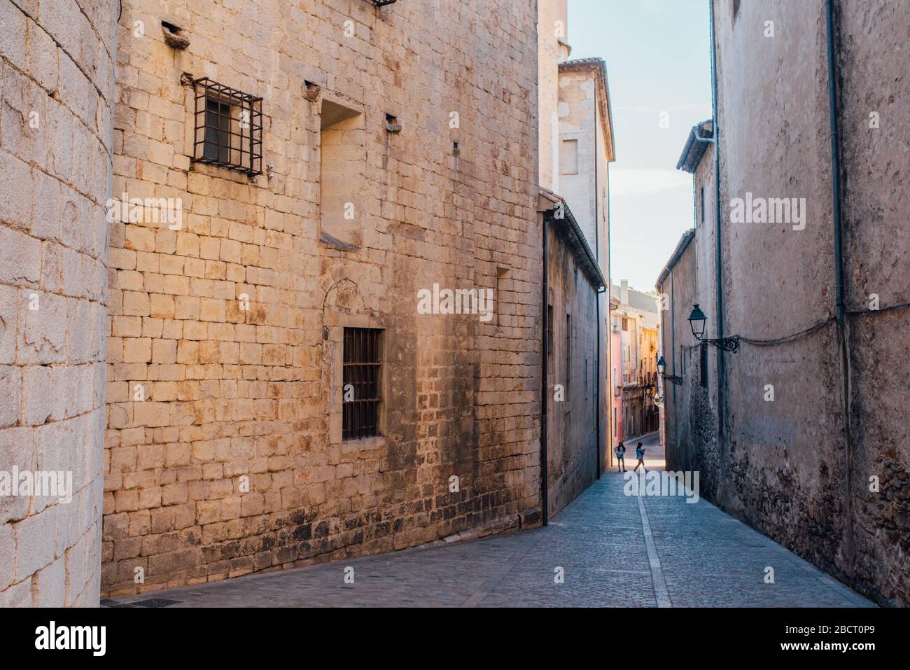 Medieval streets of Girona. Medieval alley with stone walls in Girona ...