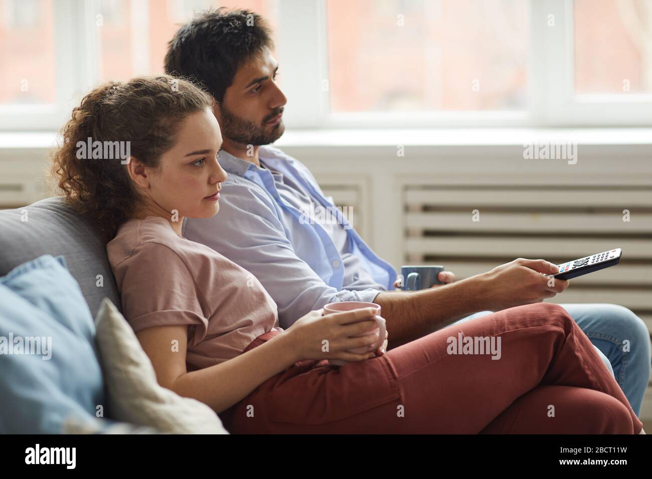 Man sofa watching tv side view hi-res stock photography and images - Alamy
