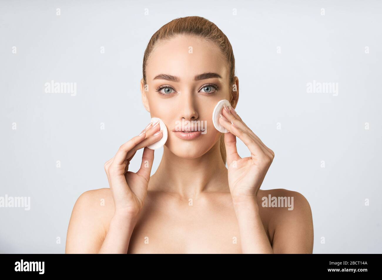Beautiful Girl Cleaning Face With Cotton Pads Over Gray Background ...