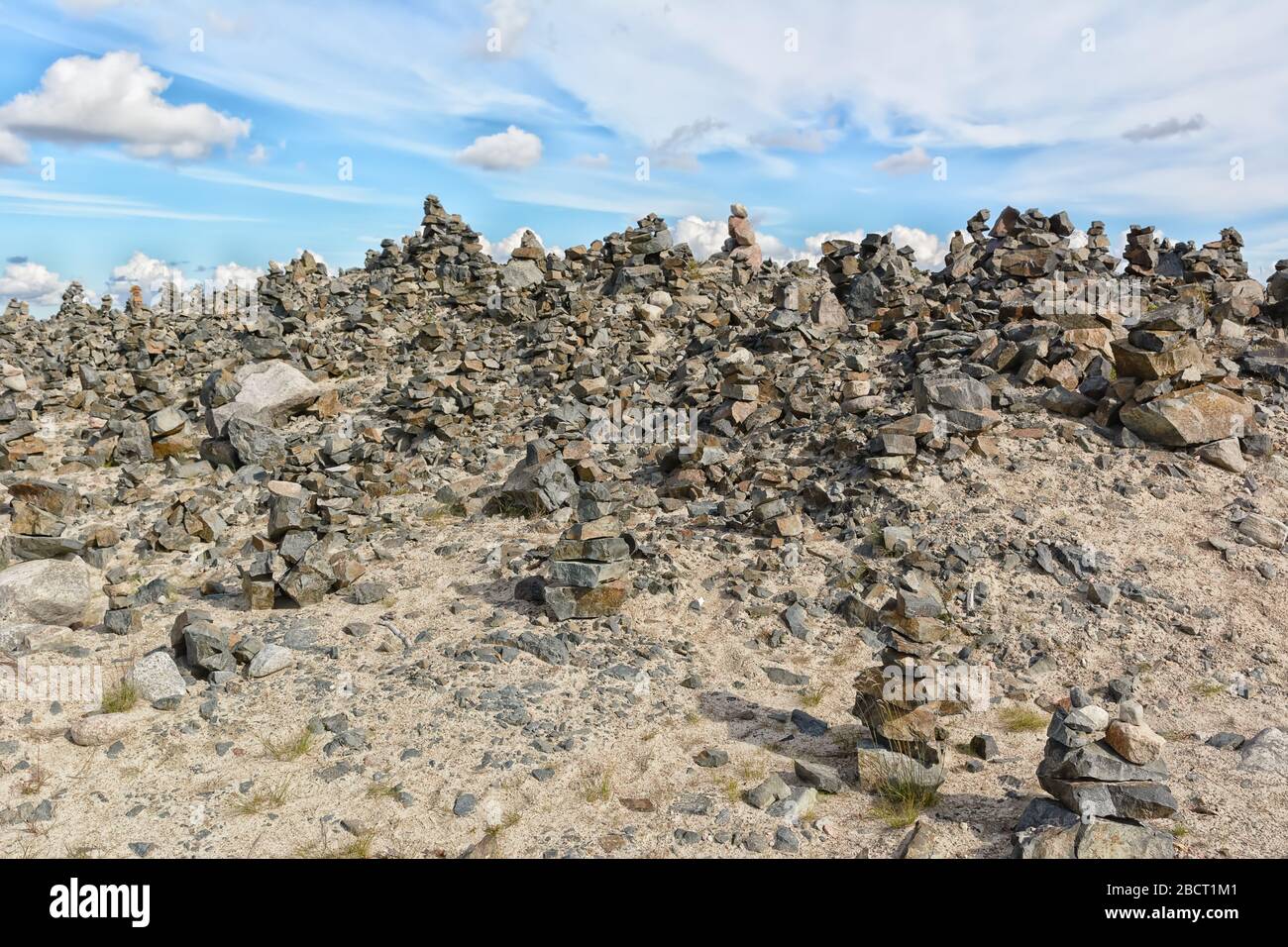 Touristic pyramid balanced stack of stones at the summer tundra. Way to ...