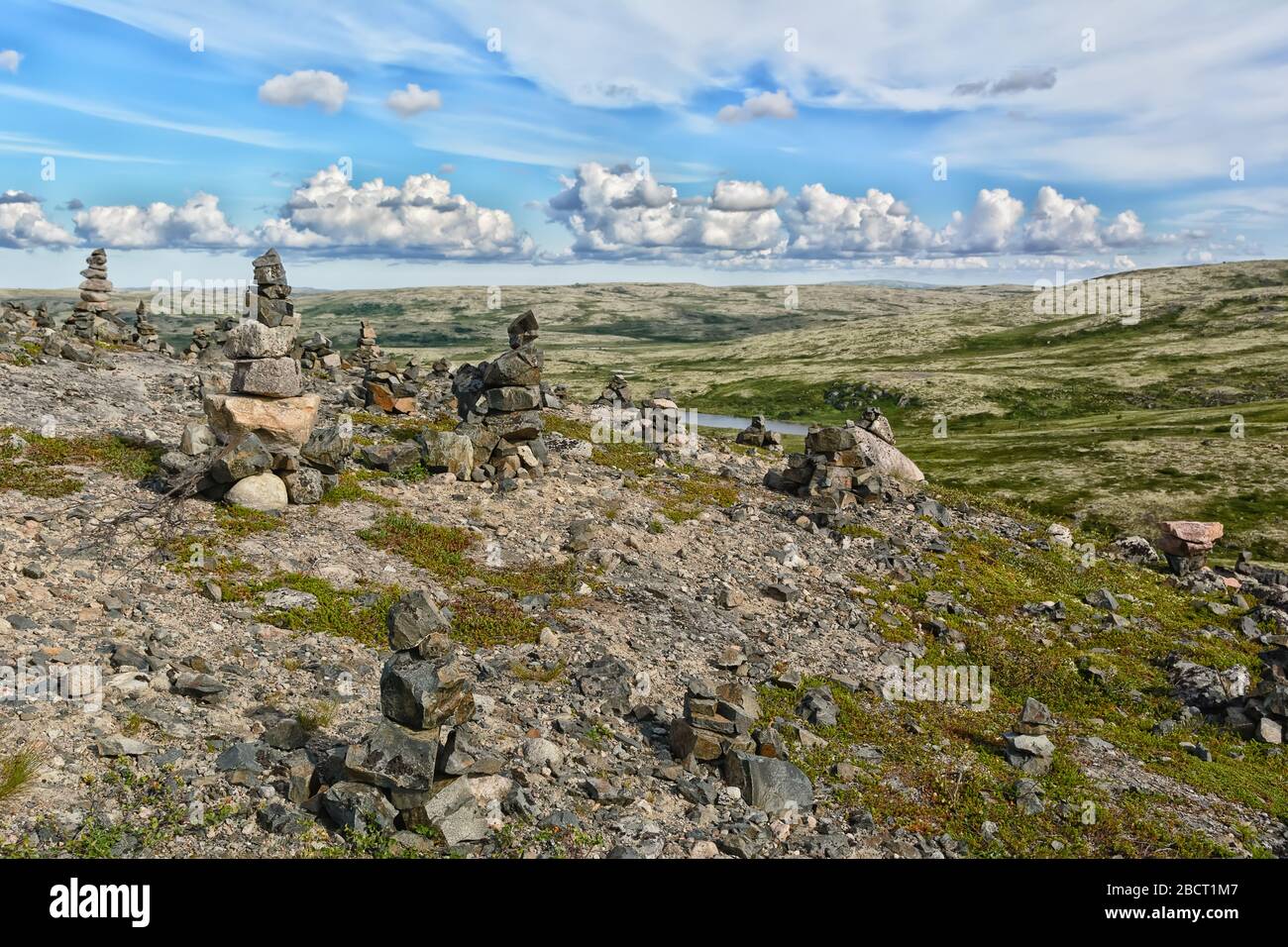 Touristic pyramid balanced stack of stones at the summer tundra. Way to ...