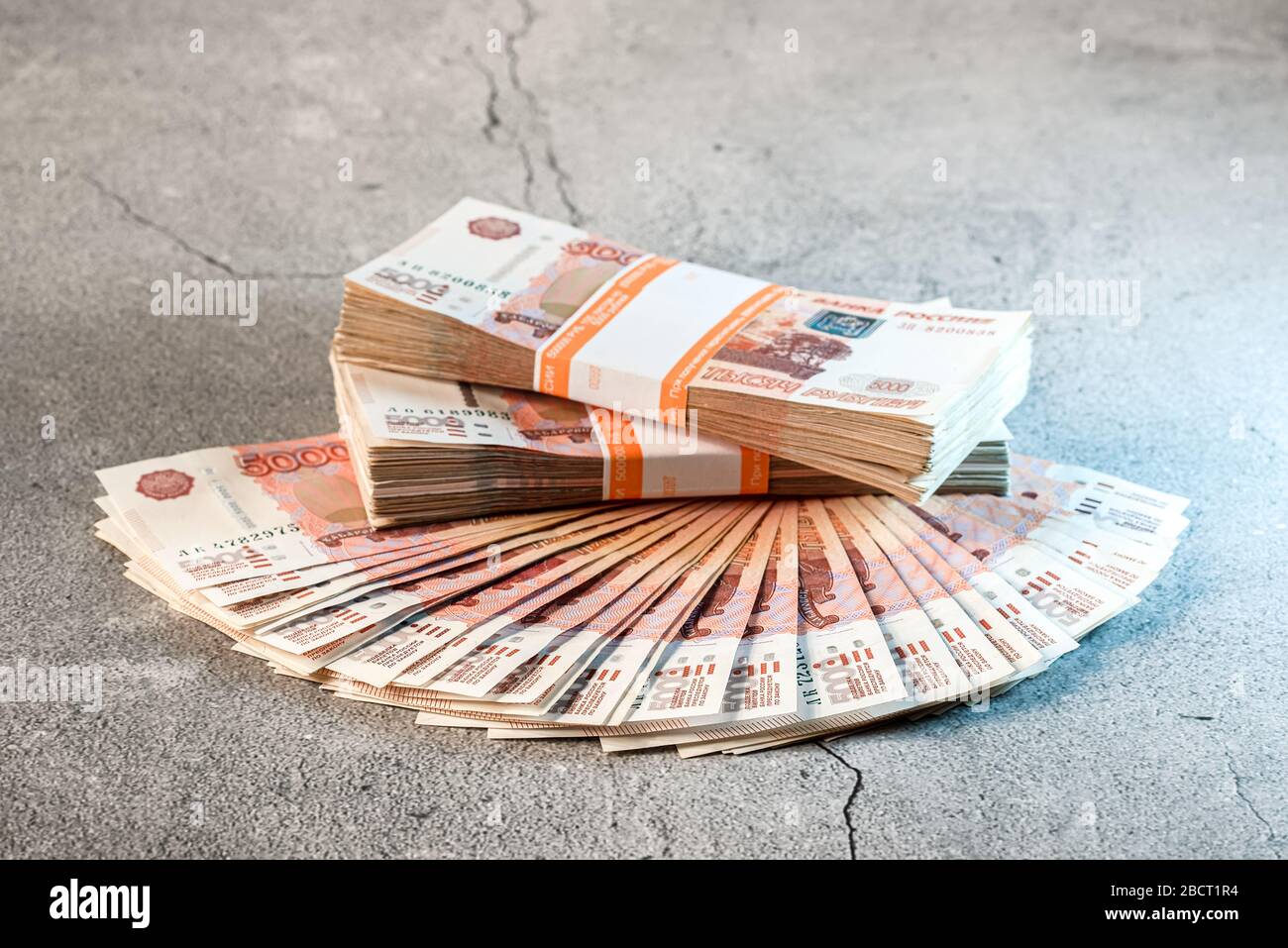 Large stack and fan of banknotes, Russian rubles laying on a grey ...