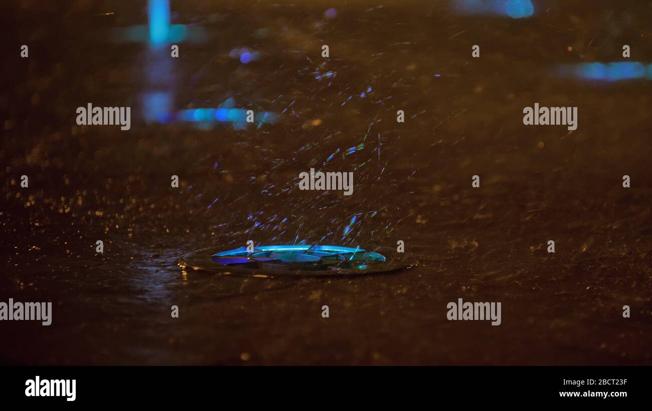 Splashes of colorful fountain. Water illuminated in diverse colors ...