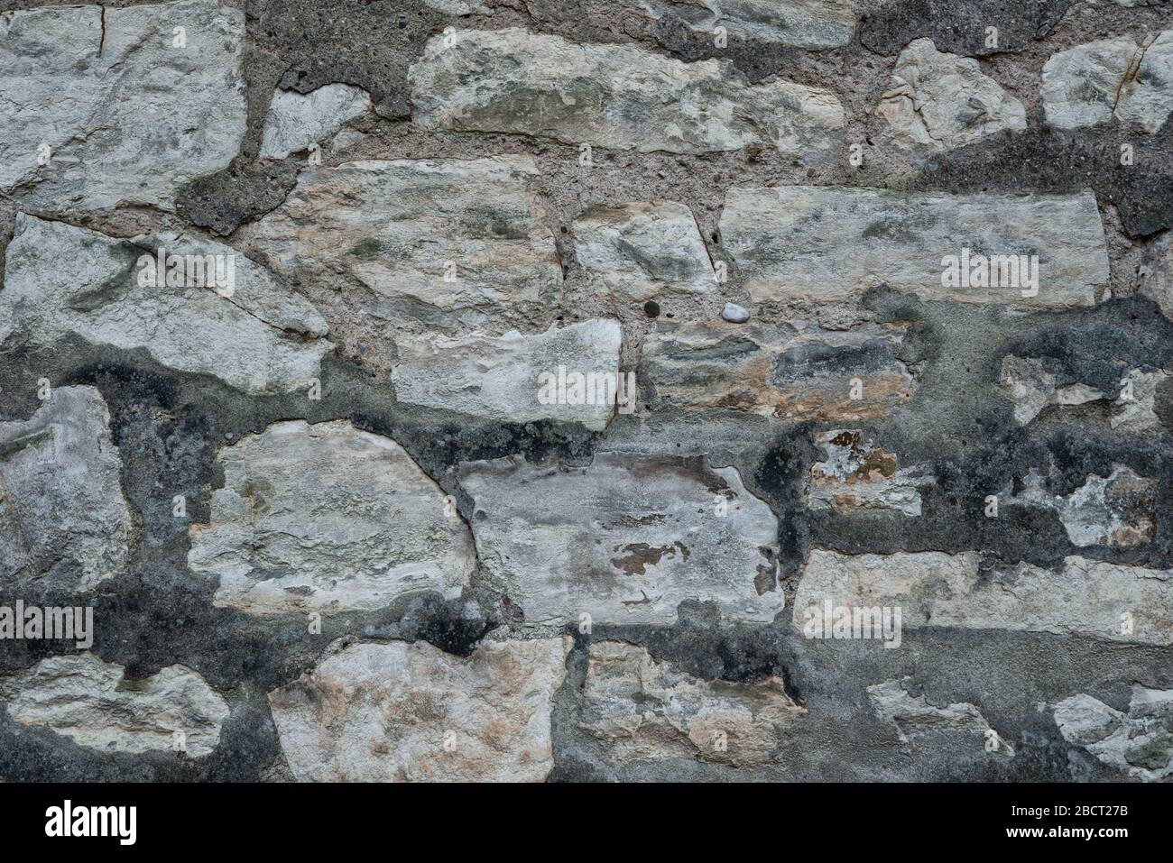 Ancient grey round stone wall flat background closeup Stock Photo - Alamy