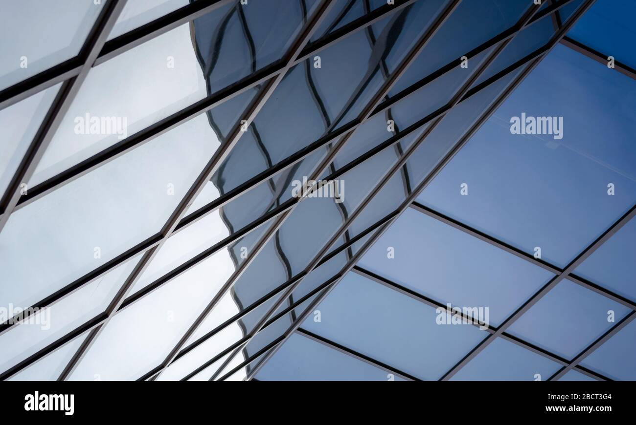 reflection with distortion in the window of a modern building color ...