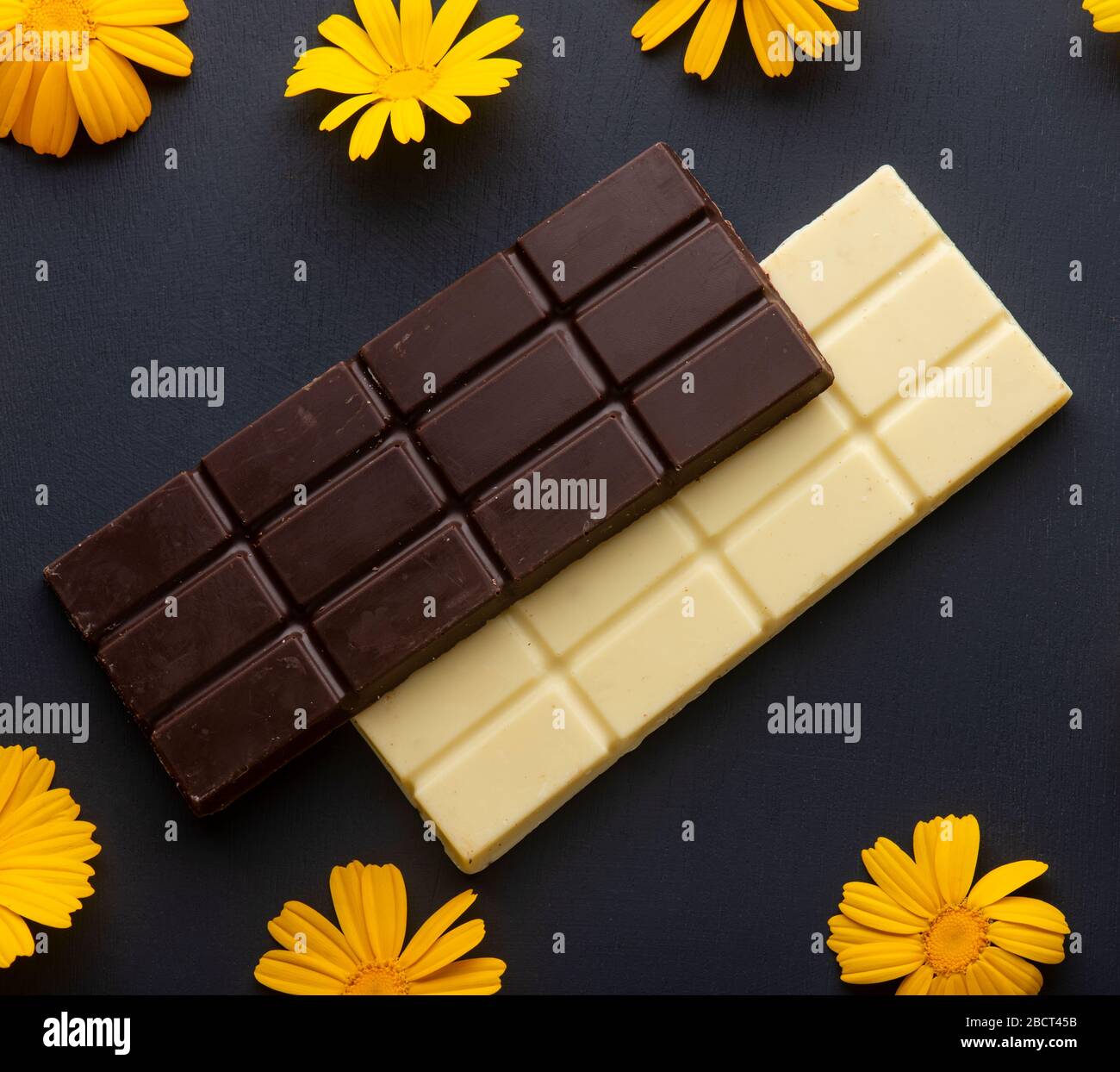 dark and white chocolate bars with yellow flowers Stock Photo - Alamy