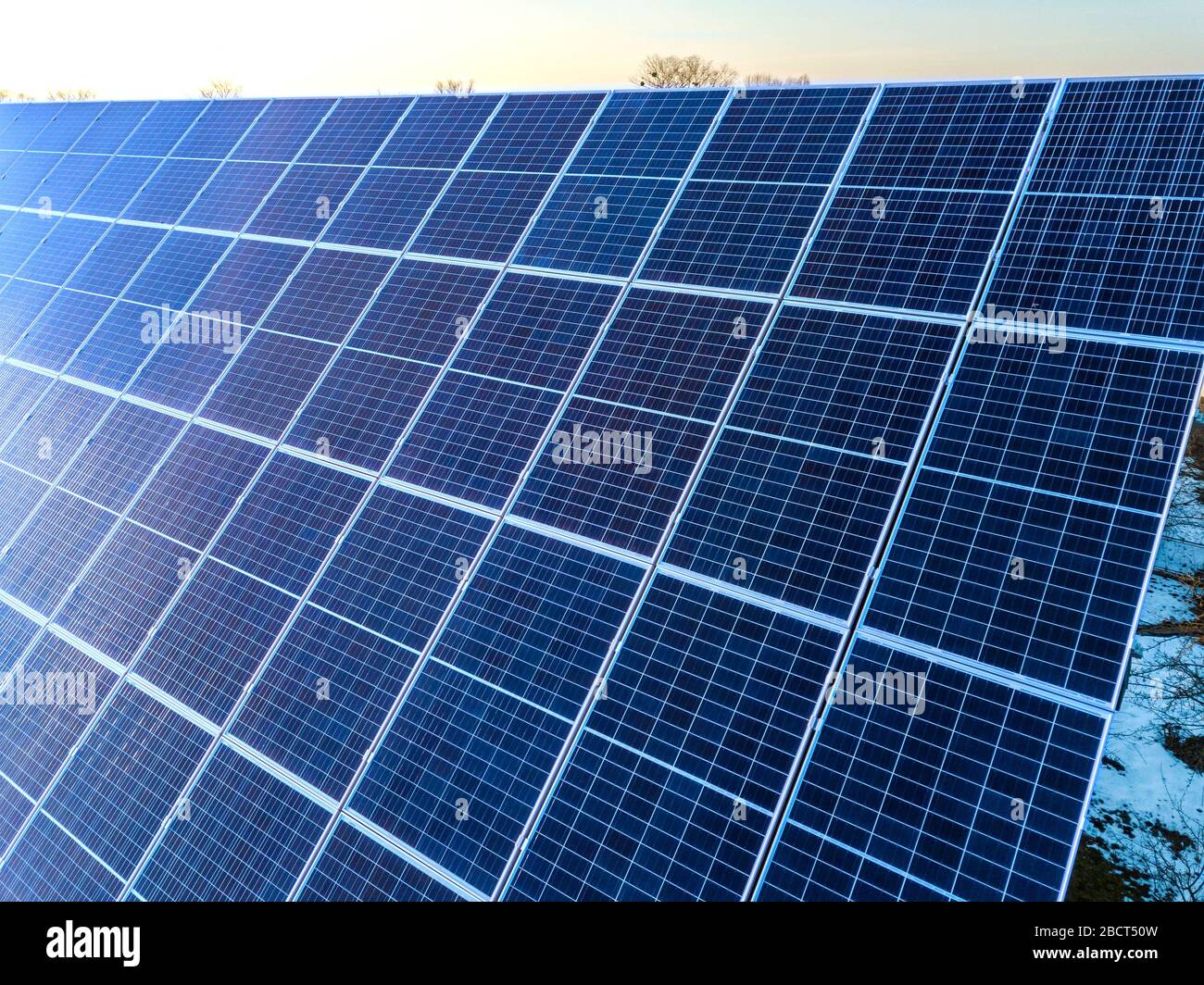 Close-up surface of lit by sun blue shiny solar photo voltaic panels ...