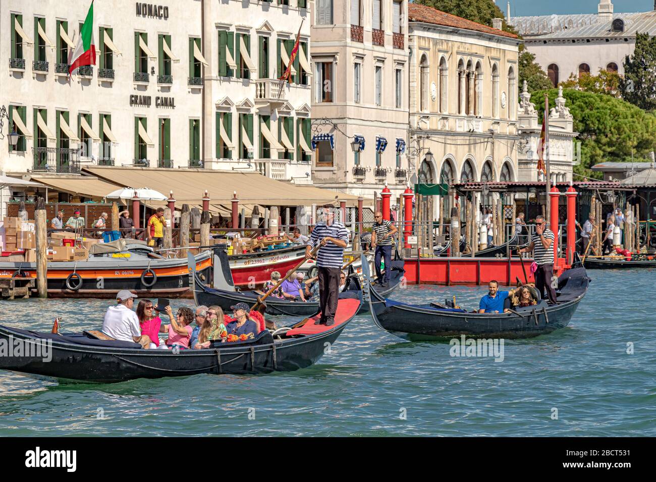 Tourists Taking Gondola Rides On The Grand Canal Near St Marks Square