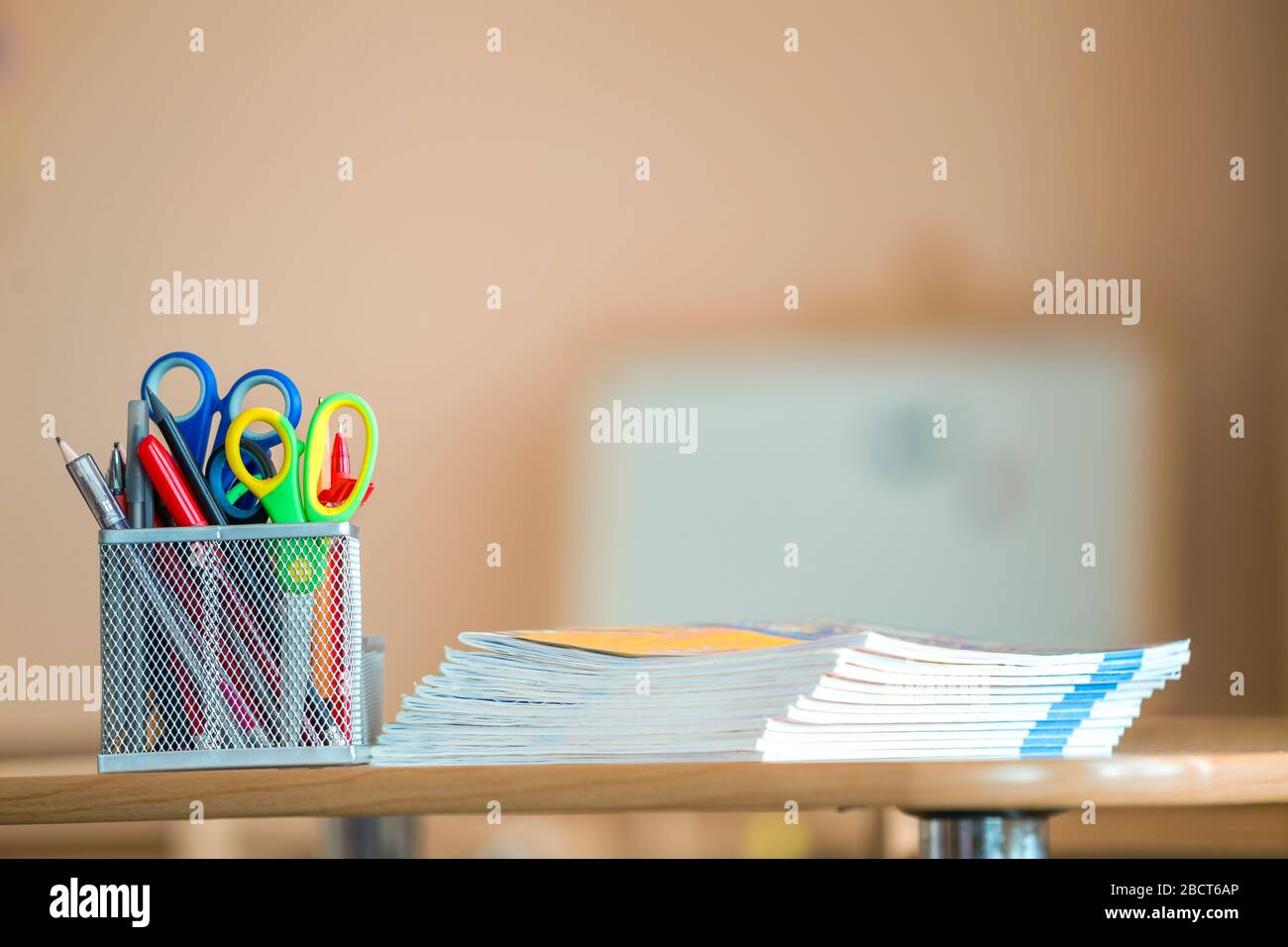 Stack of notebooks and stationery arrangement in classroom or office on ...