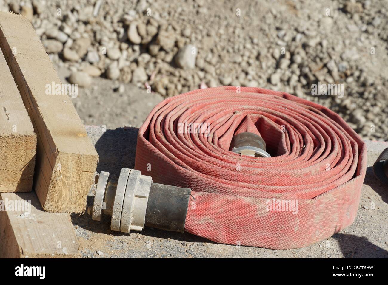 a hose on a construction or a building place coiled up on the ground in ...
