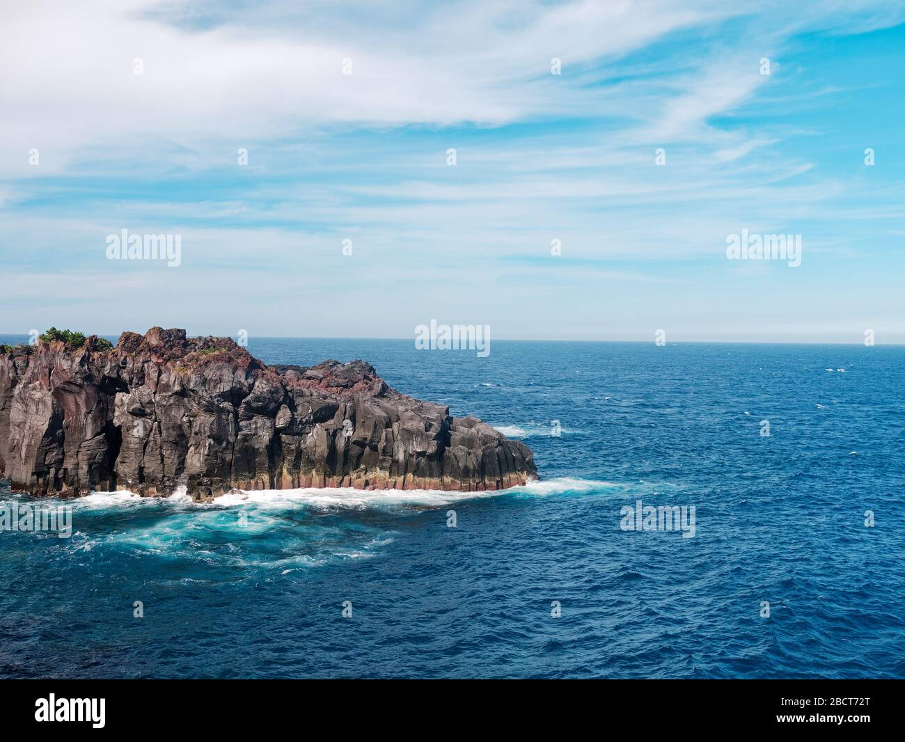 View of wild rocky cliffs with columnar joints and the pacific ocean ...
