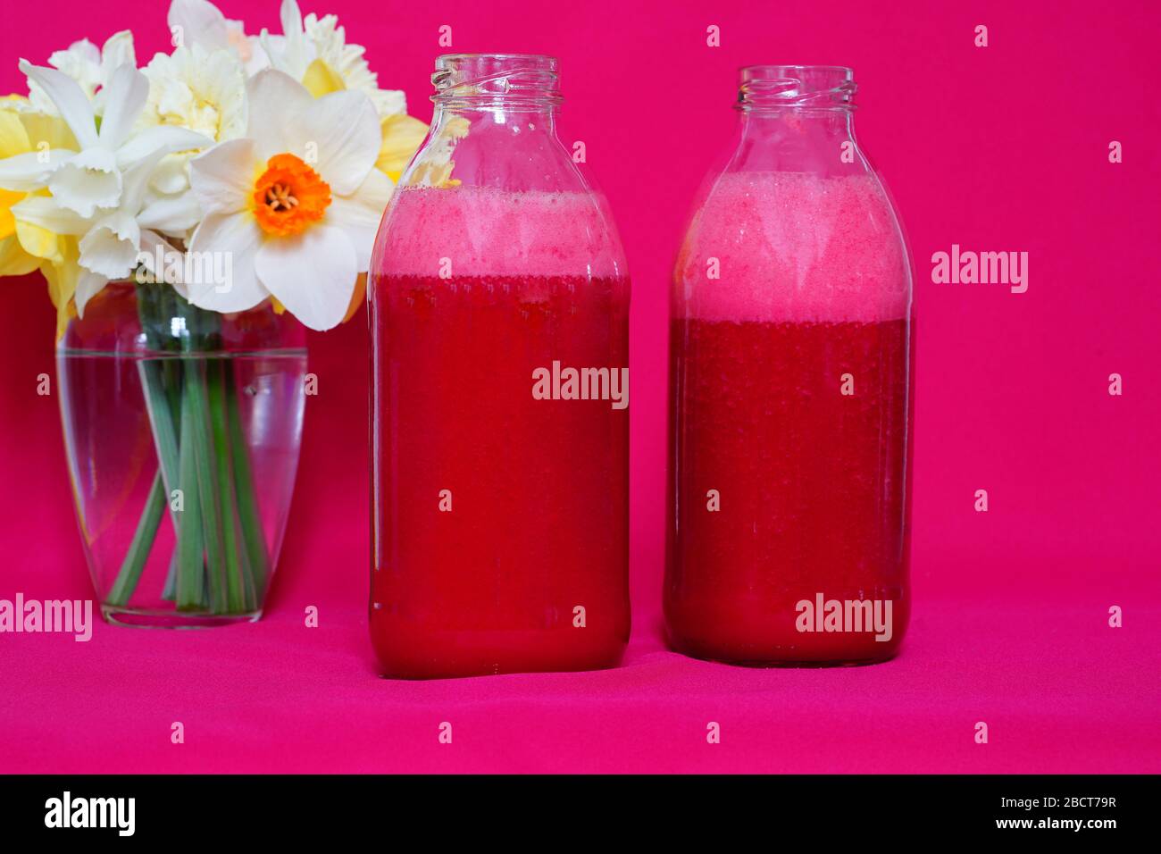 Glass bottles filled with colorful fresh homemade beet smoothies Stock ...
