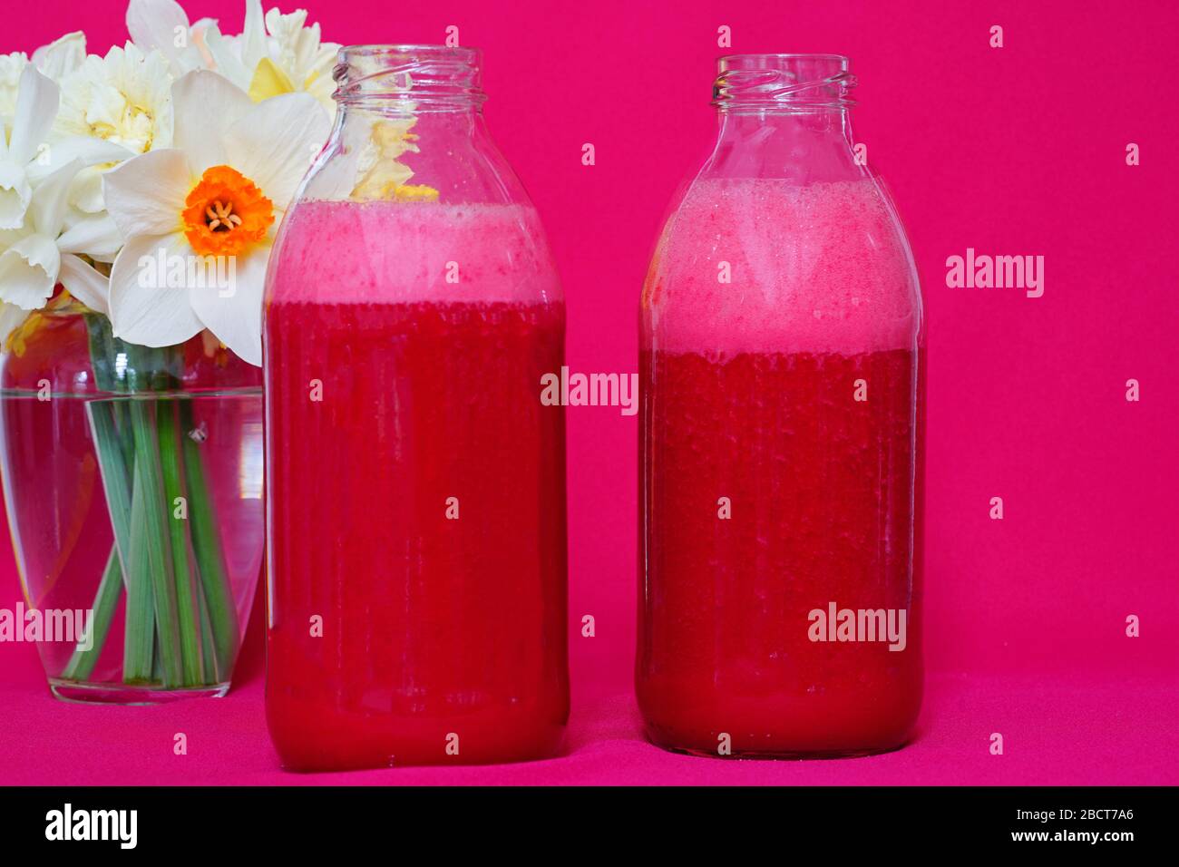 Glass bottles filled with colorful fresh homemade beet smoothies Stock ...