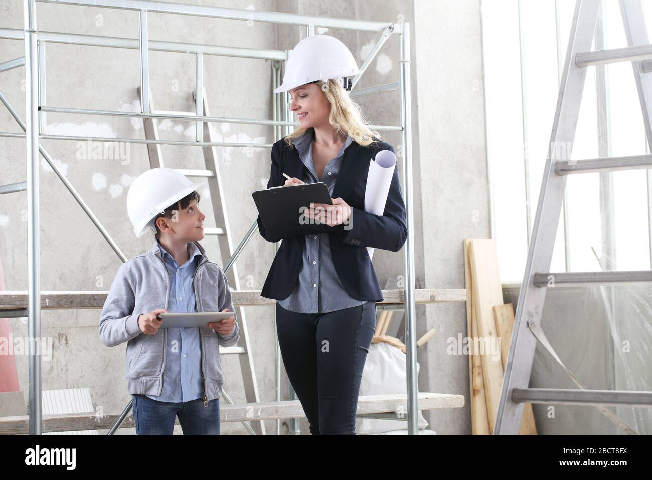 woman interior designer or architect mom with her son they work ...
