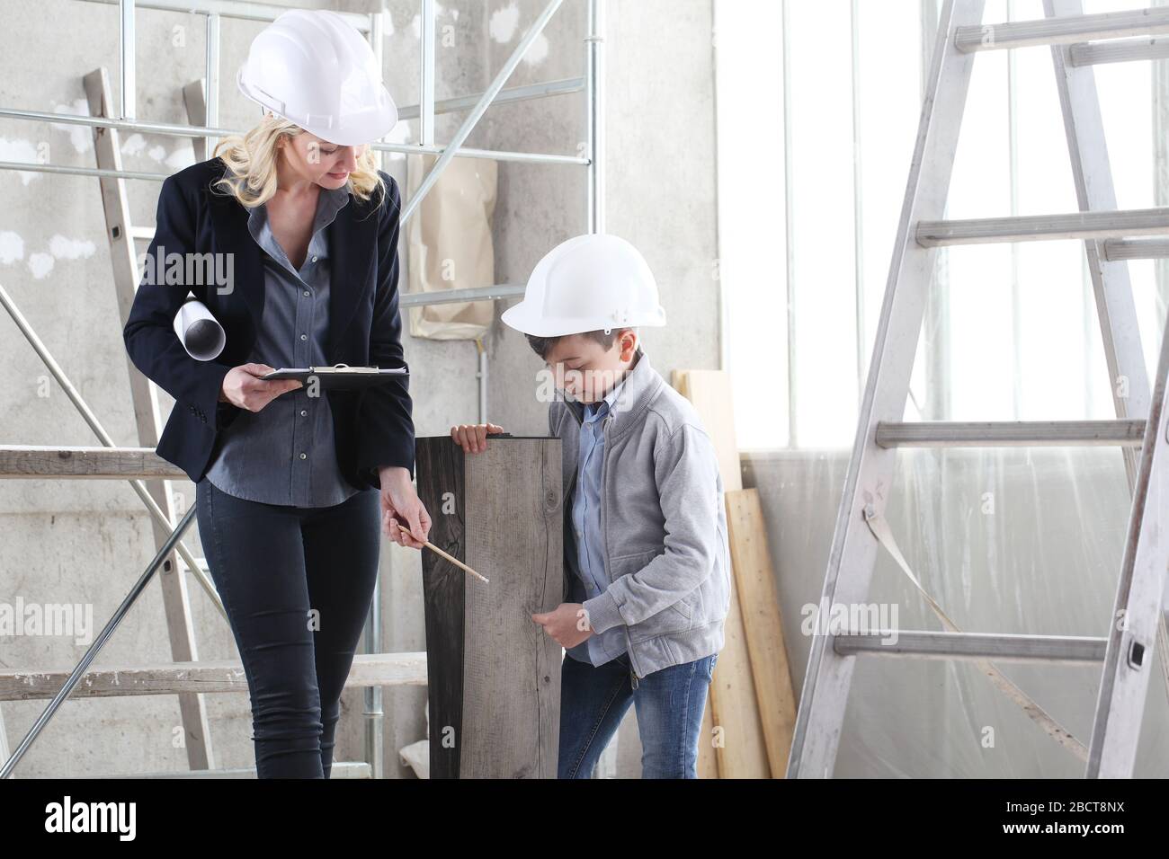 woman interior designer or architect mom with her son at work, they ...