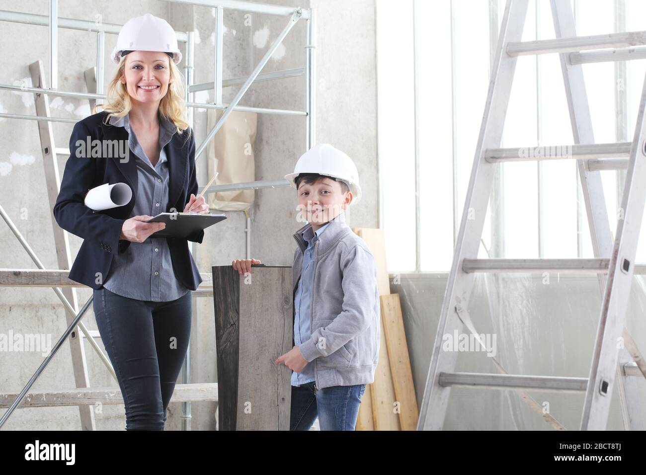 woman interior designer or architect mom with her son at work, they ...