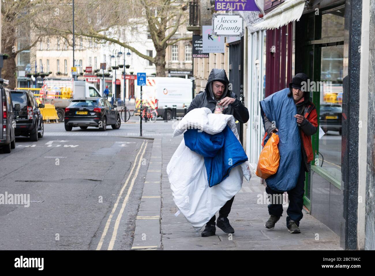 Bath, North Somerset, UK. 31st March 2020. Two homeless people walk the ...
