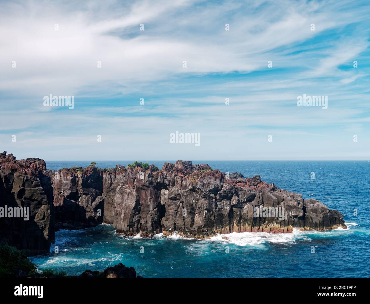 View of wild rocky cliffs with columnar joints and the pacific ocean ...