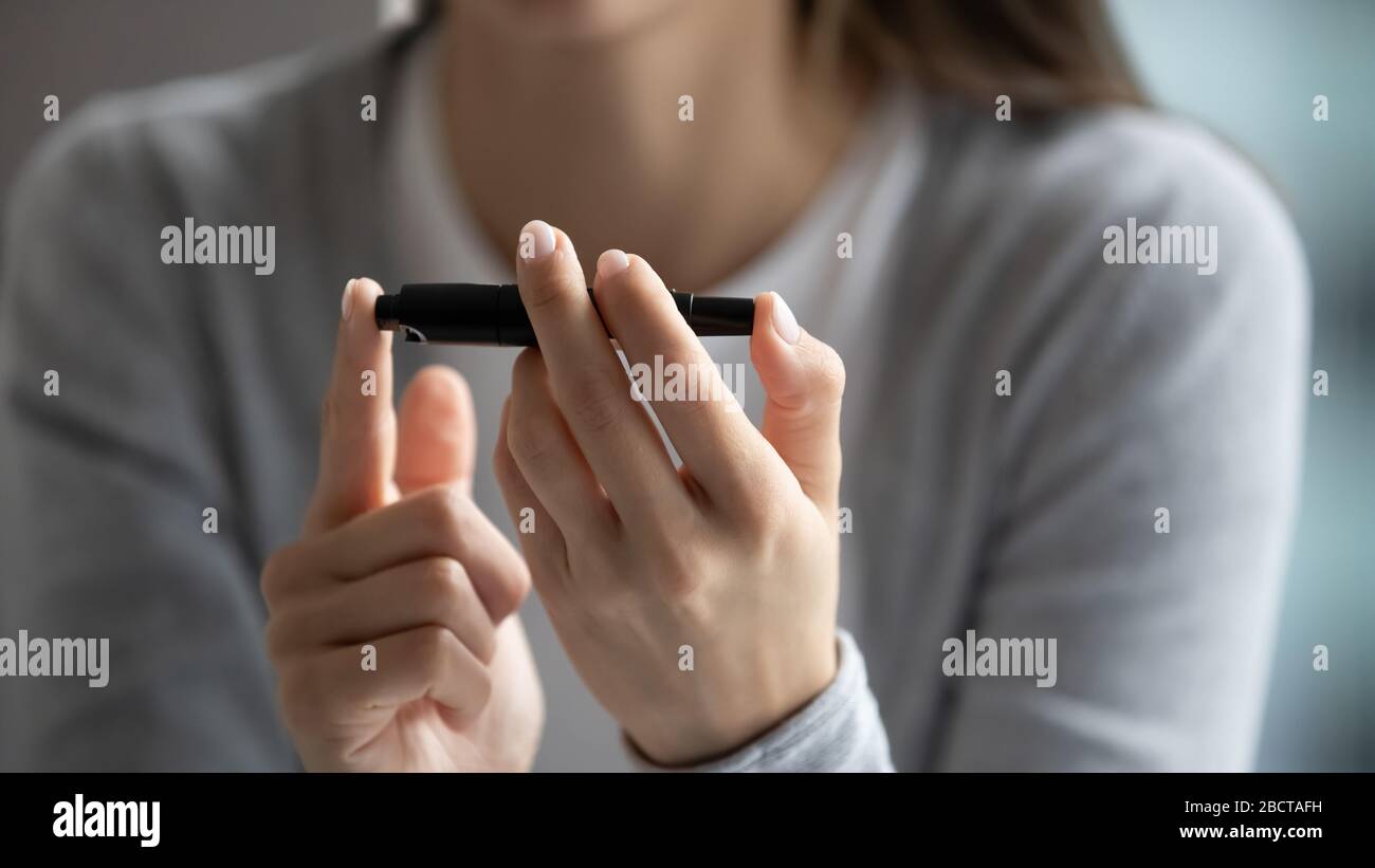 Young woman check sugar level using glucose meter Stock Photo - Alamy