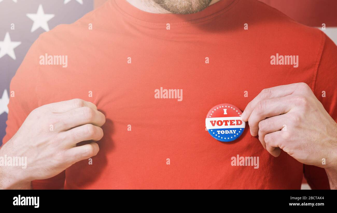 Man putting on I Voted Today button for Presidential election 2020 in ...