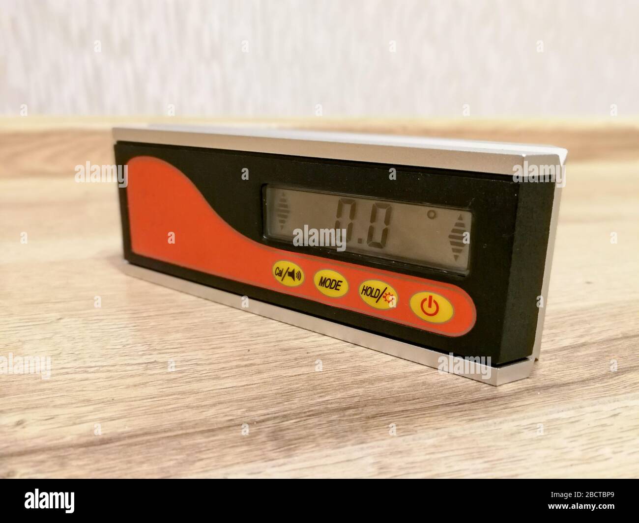 Professional digital tool inclinometer on the wooden floor for leveling ...