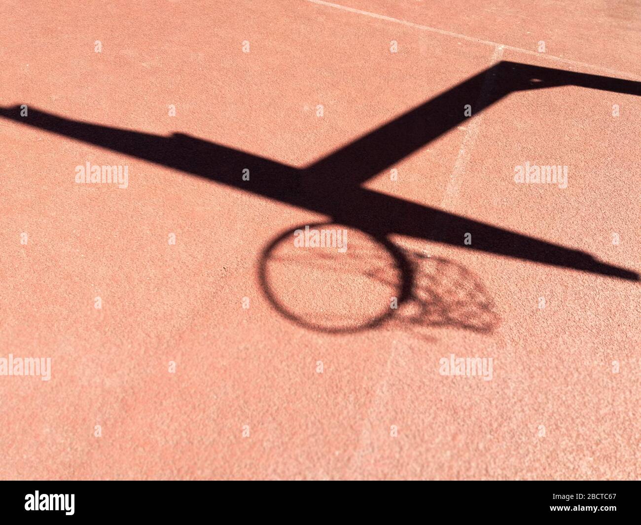 Basketball board and net shadow during the day on the basketball court ...