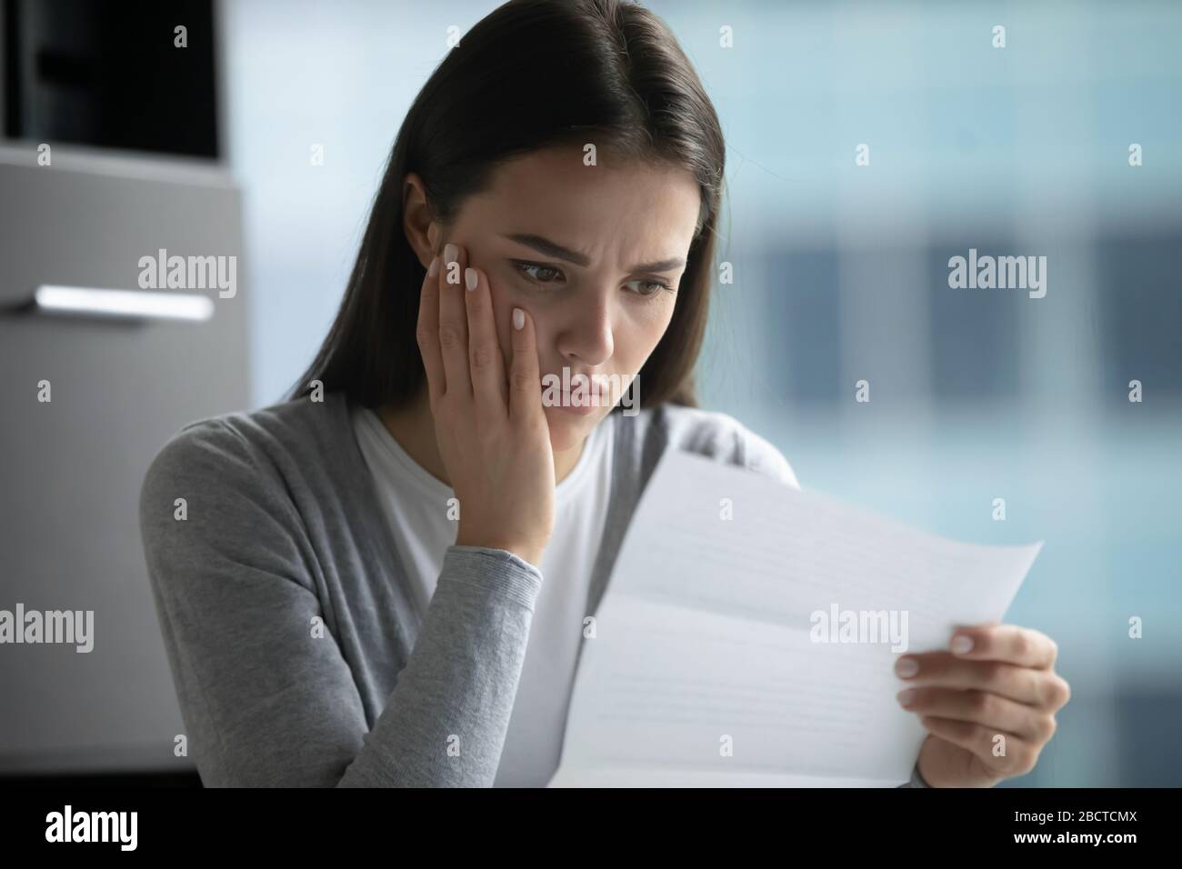 Upset young woman frustrated by bad letter correspondence Stock Photo ...