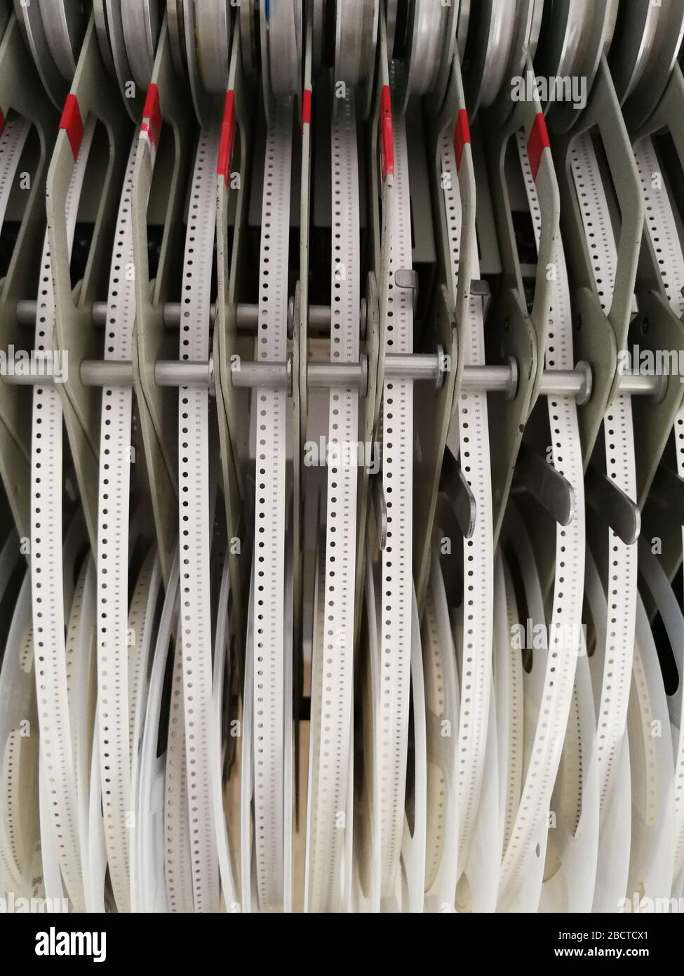 Paper reels with various electronic components resistors, capacitors ...