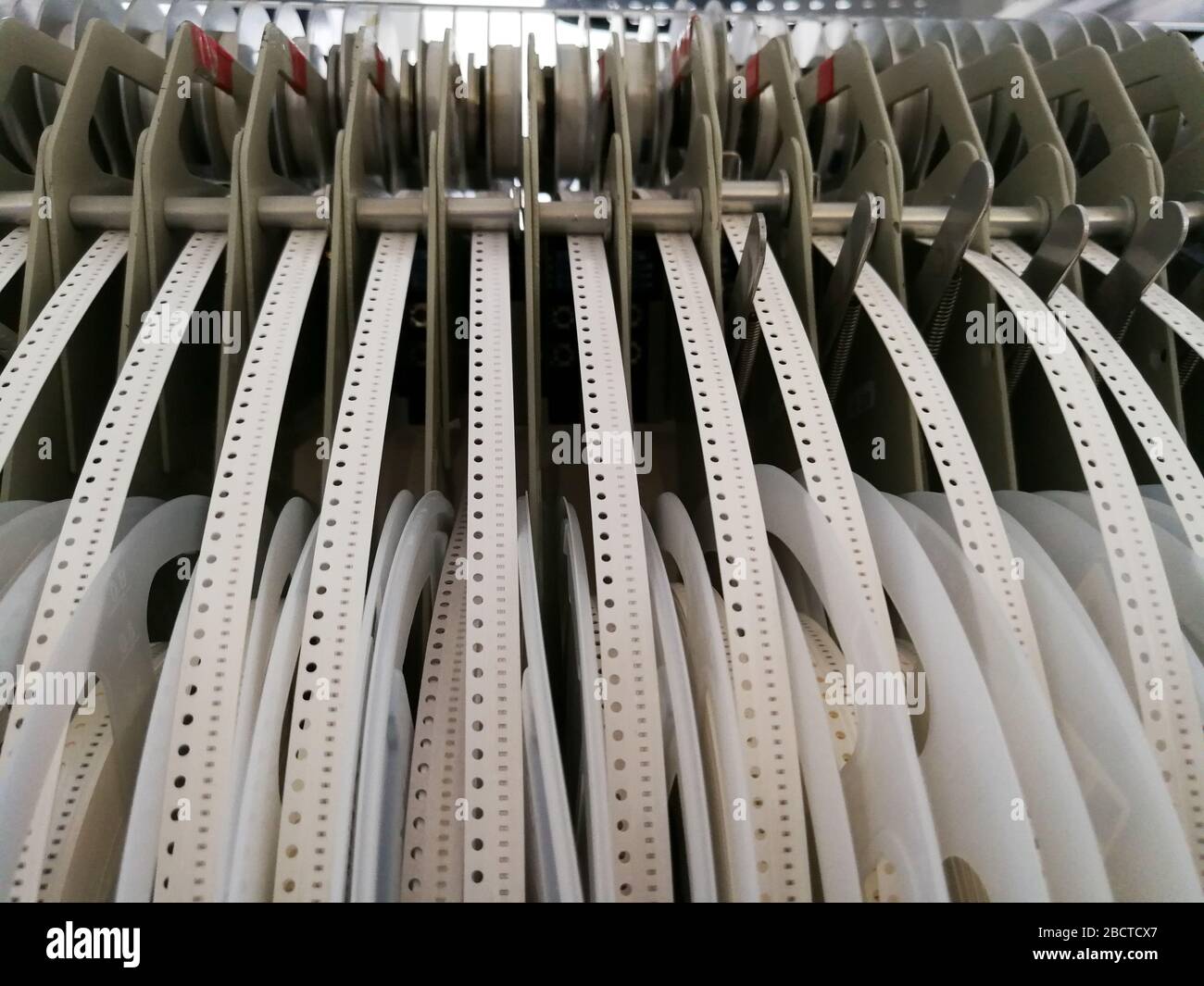 Paper reels with various electronic components resistors, capacitors ...