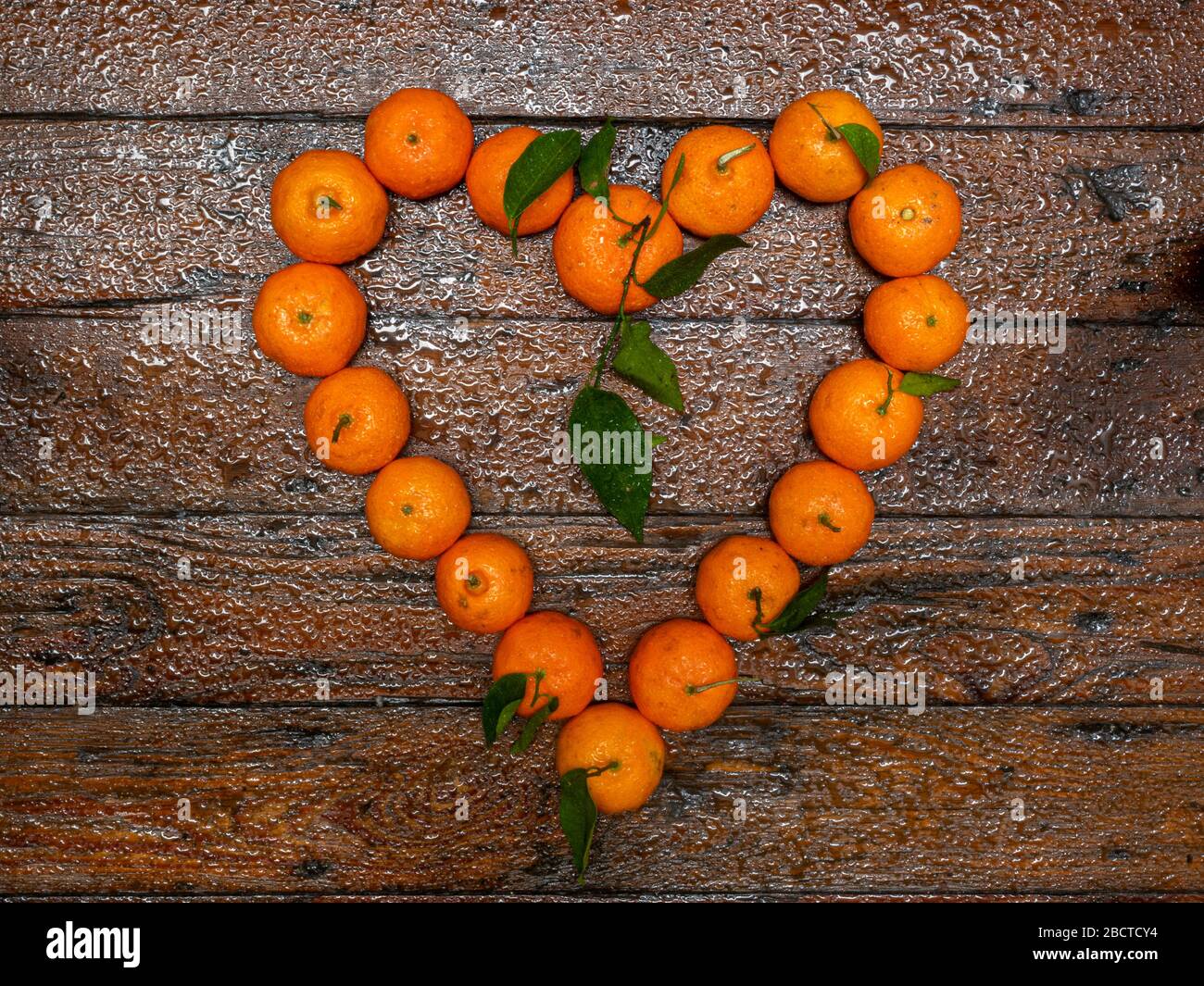 Heart shape of mandarin oranges on table Stock Photo - Alamy