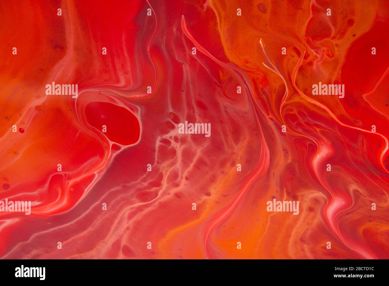 Liquid red marbling smooth stains paint background Stock Photo - Alamy