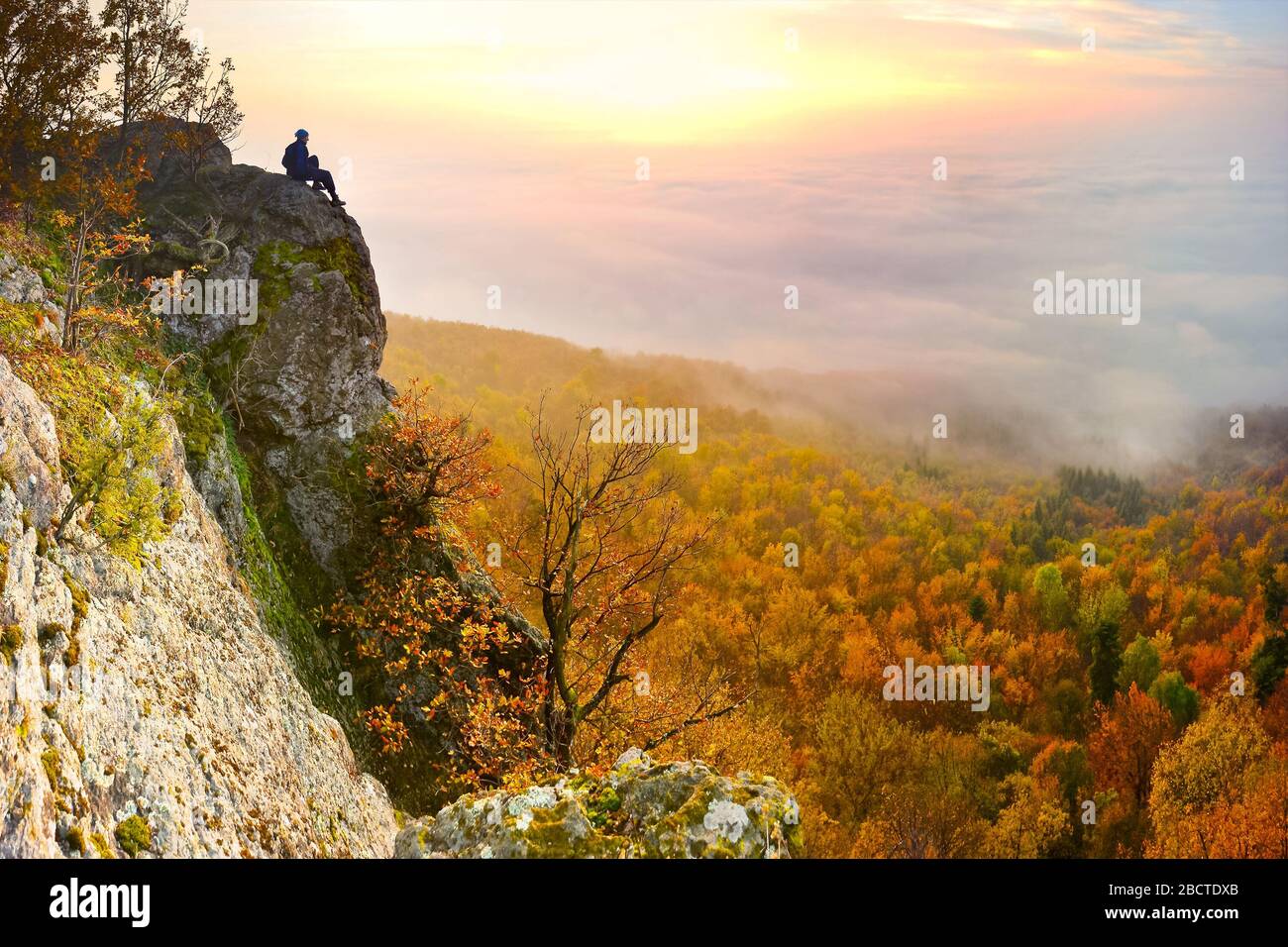 Sunrise with inversion above the deep autumn valley of mountains with ...
