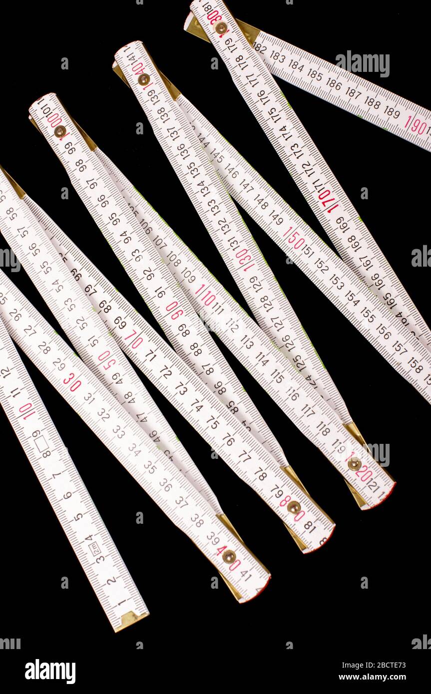 White carpenter's ruler isolated on the black background Stock Photo ...