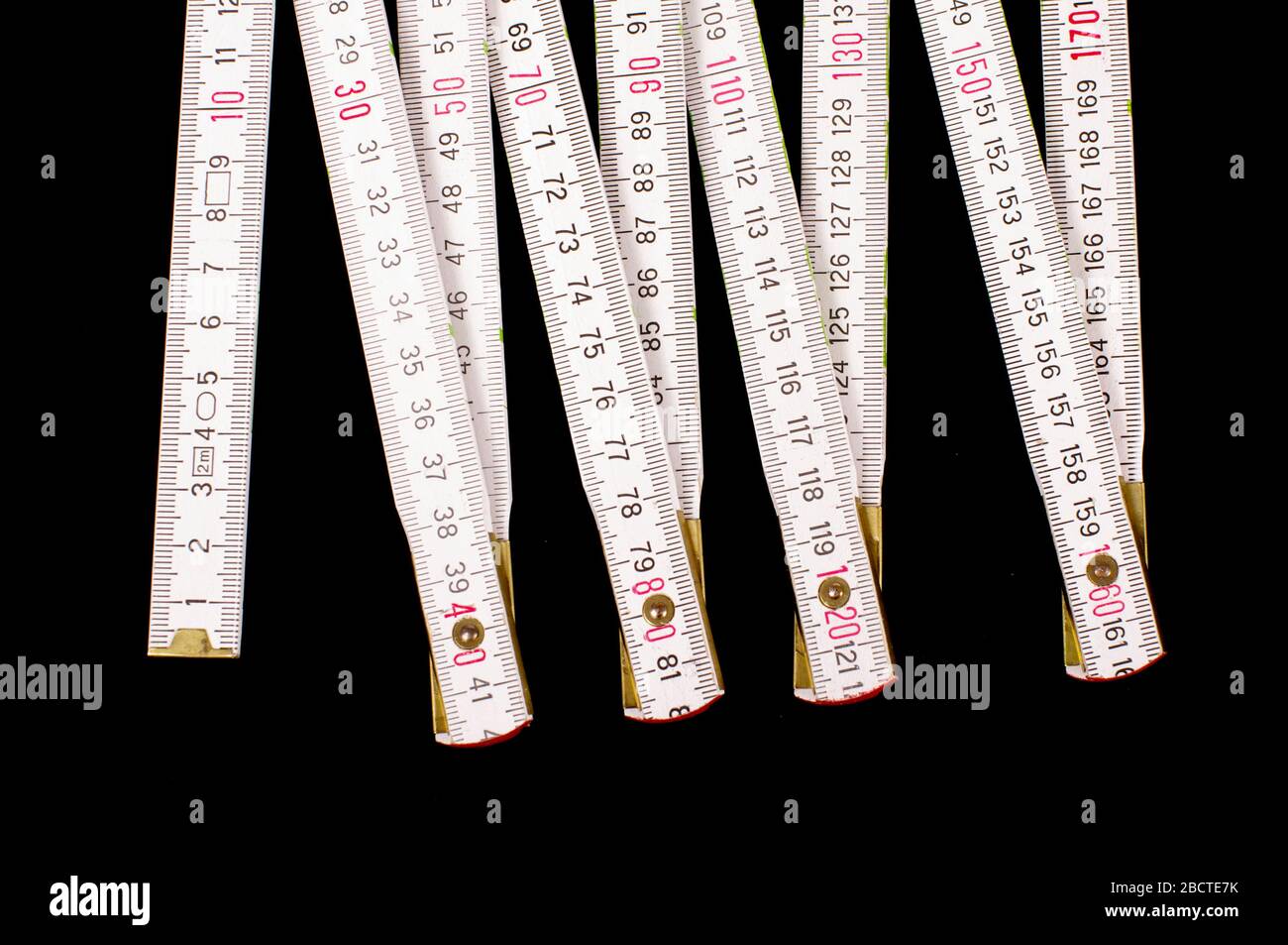 White carpenter's ruler isolated on the black background Stock Photo ...
