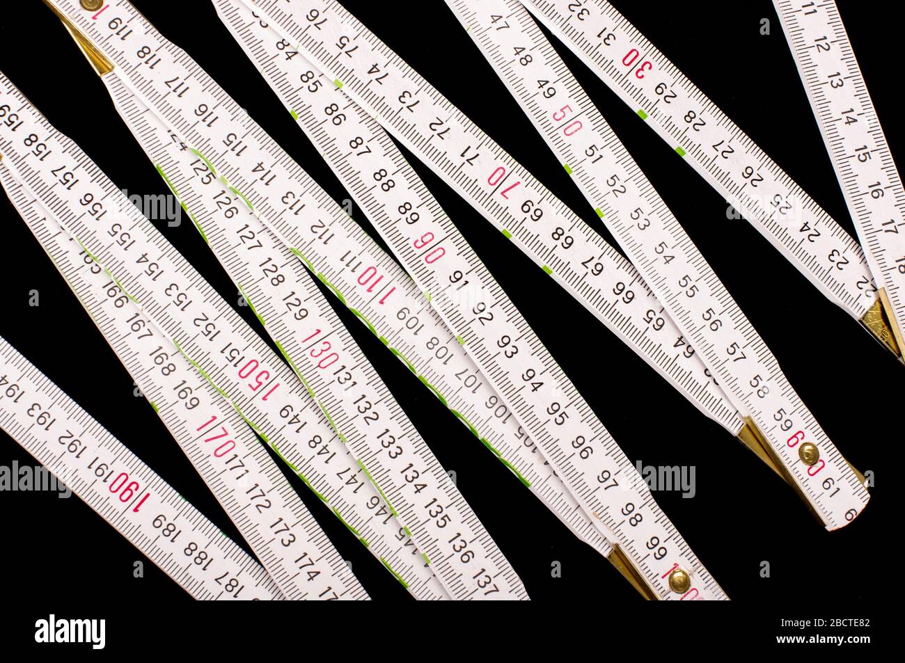 White carpenter's ruler isolated on the black background Stock Photo ...