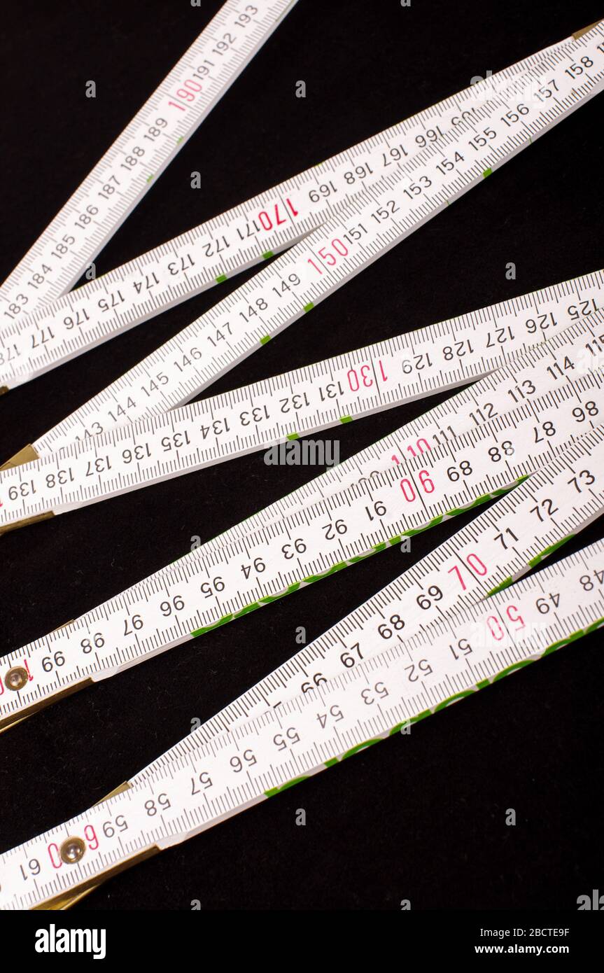 White carpenter's ruler isolated on the black background Stock Photo ...