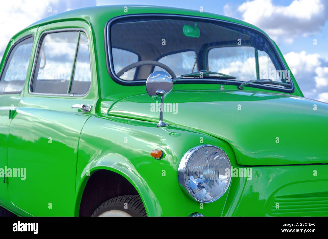 Vintage retro car. small soviet retro car of green color against the ...
