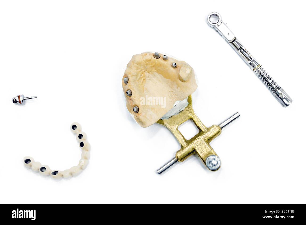 white ceramic teeth with dental implants on a white background. torque ...