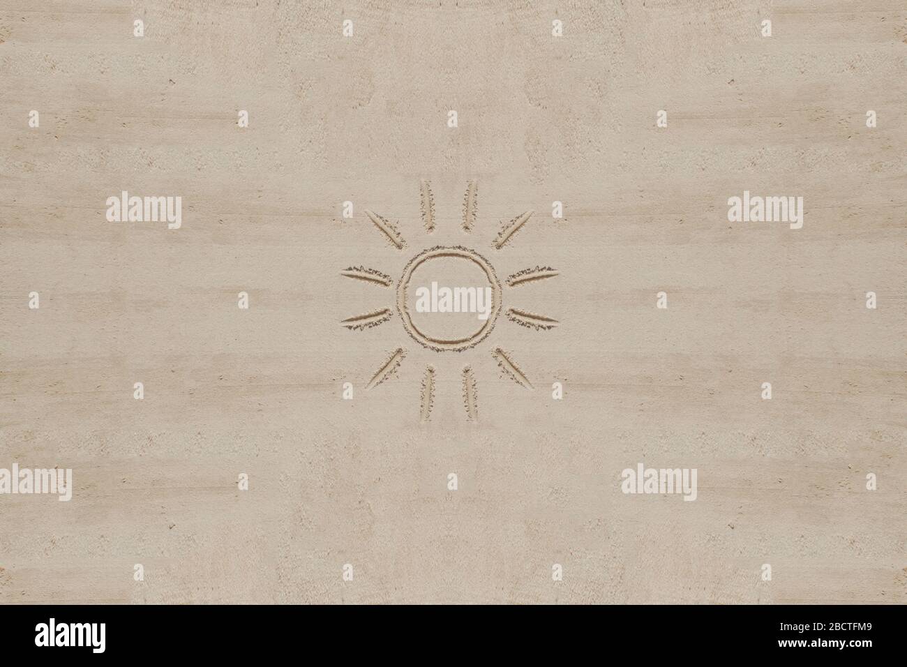 simple sun drawing in the sand on the beach, room for your copy space ...