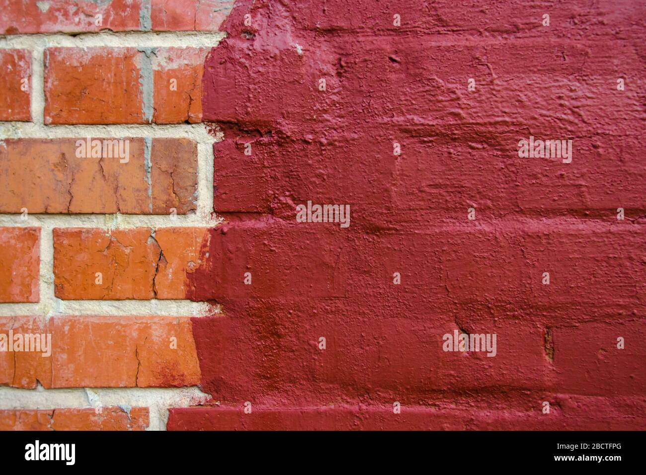 red brickwork half painted in dark red paint Stock Photo - Alamy