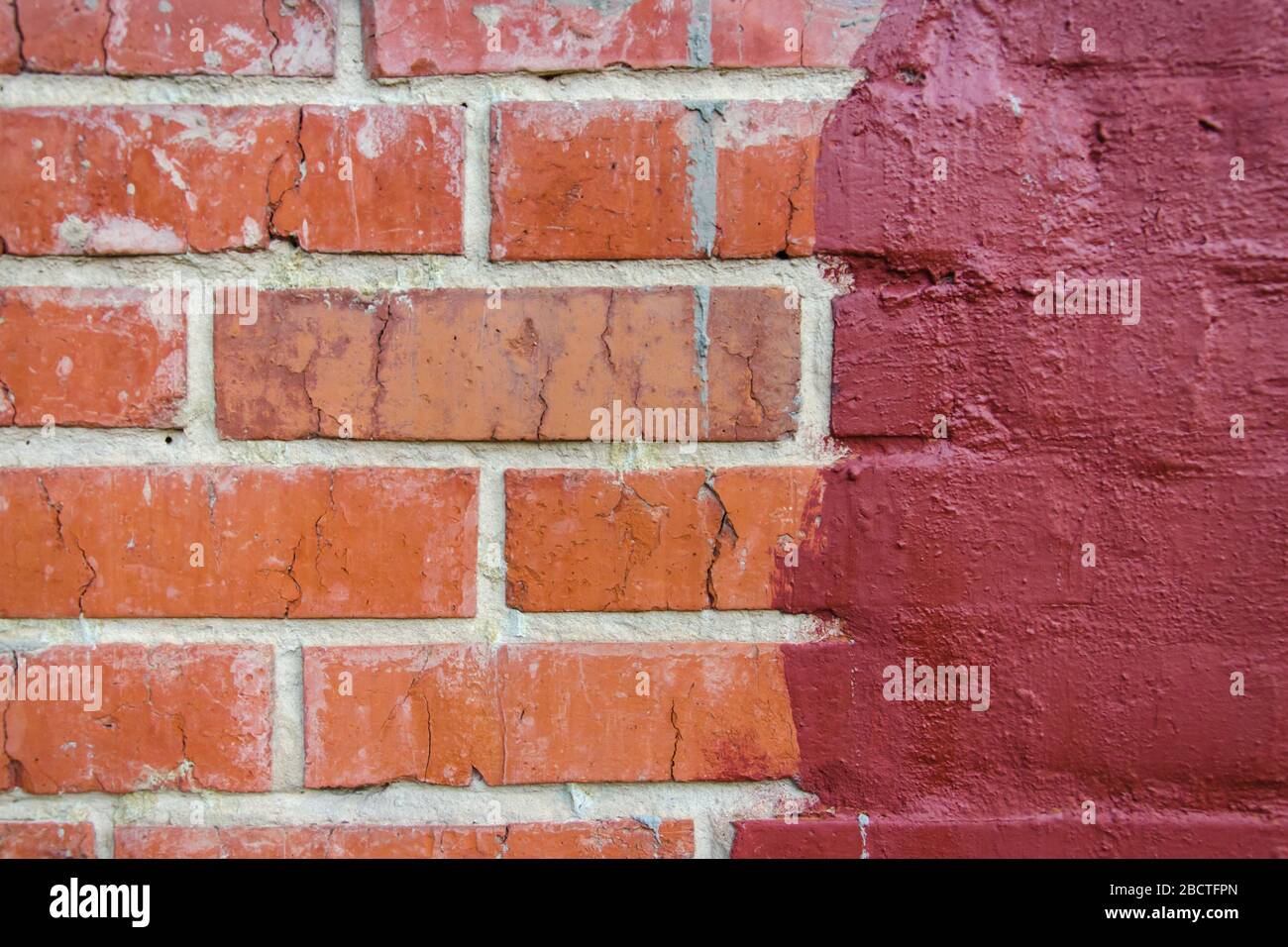 red brickwork half painted in dark paint Stock Photo - Alamy
