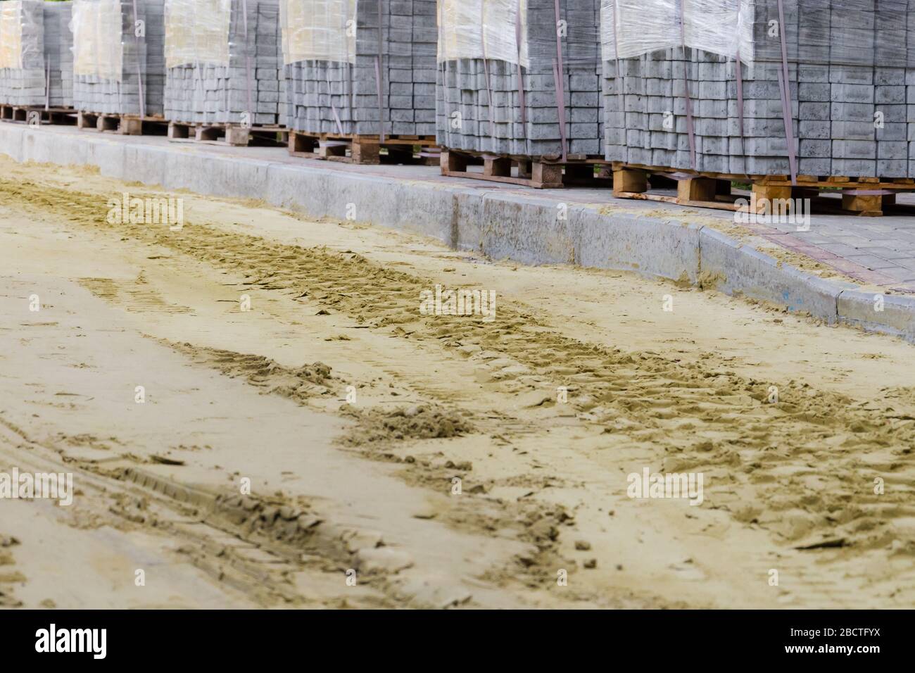 road works on laying paving slabs with laying of sand Stock Photo - Alamy