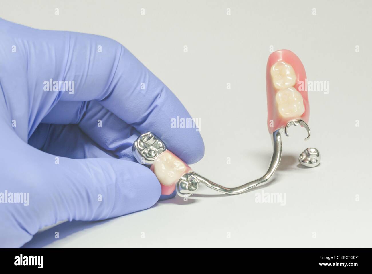 partial arch prosthesis of the lower jaw with metal crowns in the hands ...