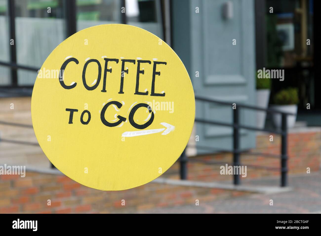 yellow retro outdoor sign coffee to go in the morning on the street ...