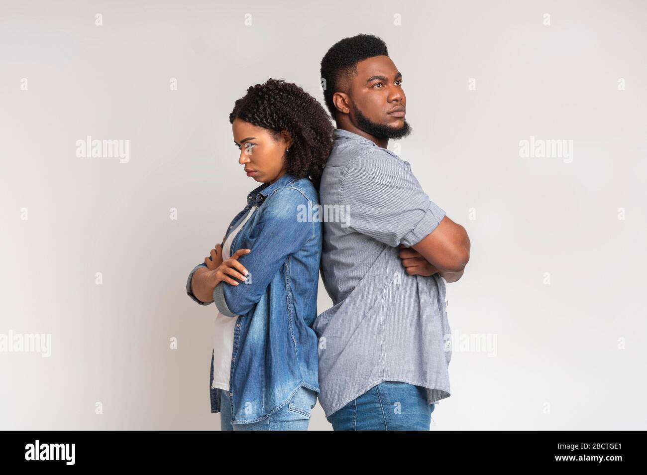 Offended black couple standing back to back ignoring each other Stock ...