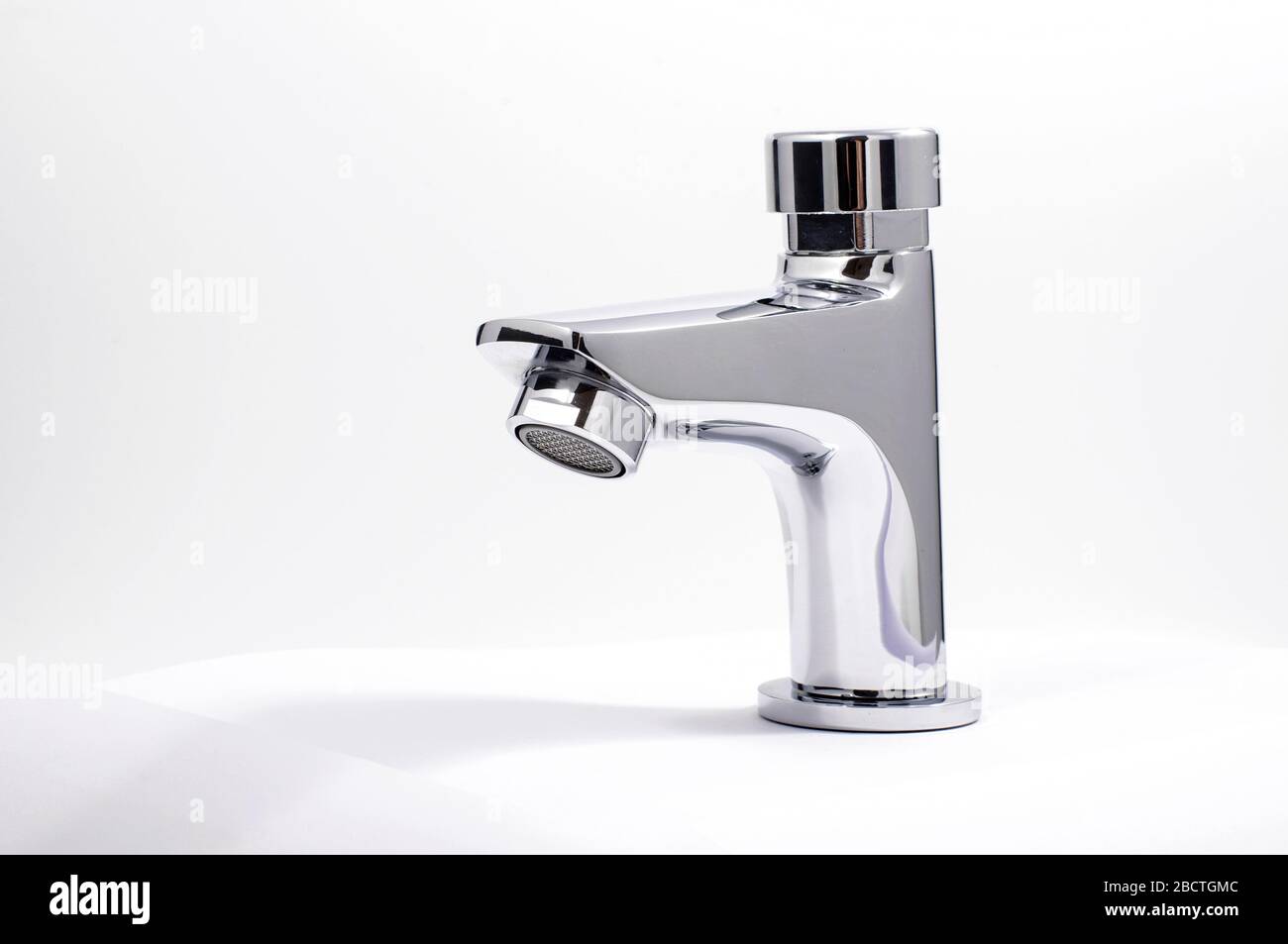 Tap on the white background Stock Photo - Alamy