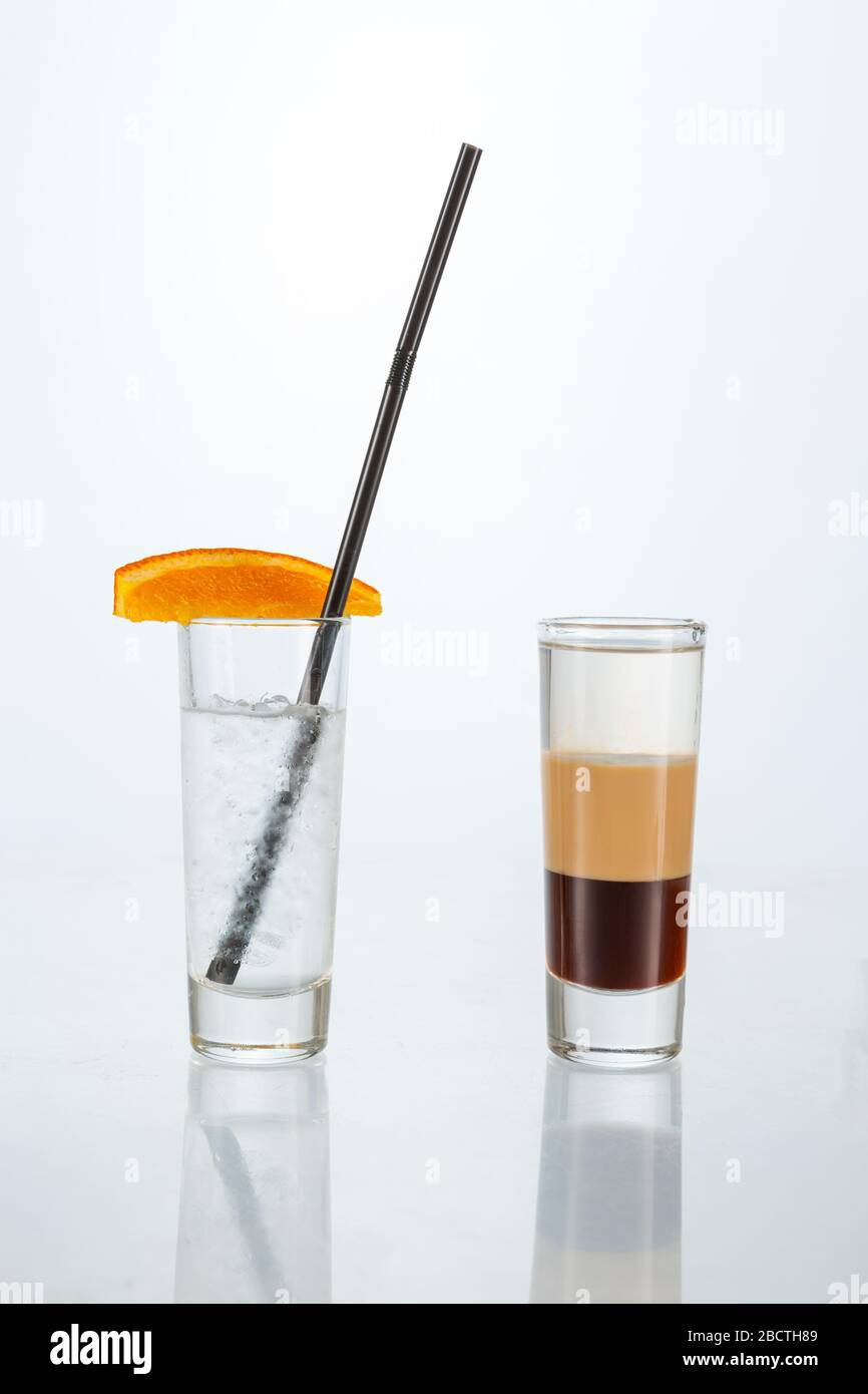 Close up of glass of b-52 cocktail on white background with copy space ...