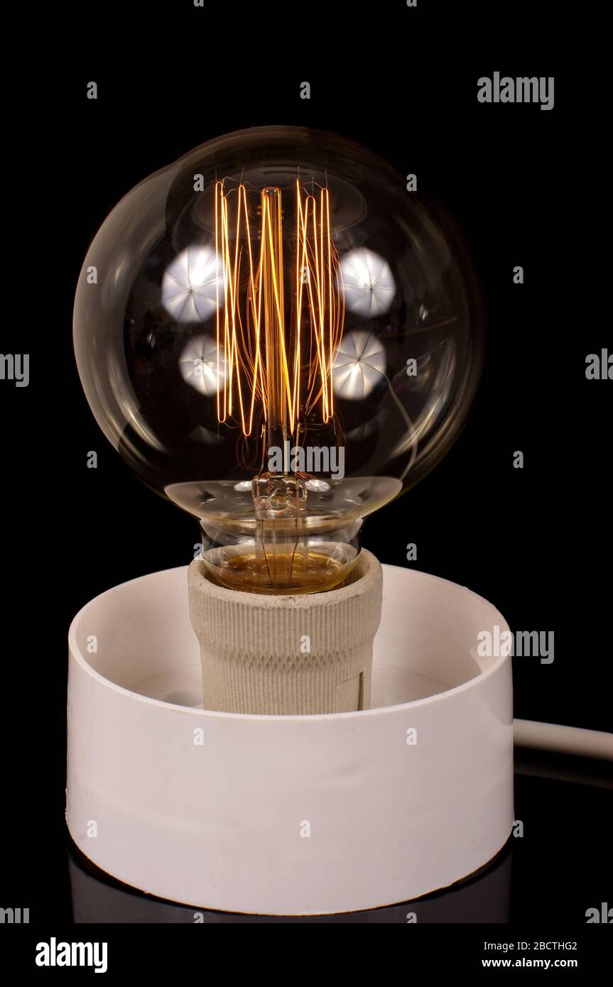 Old style light bulb with filament Stock Photo - Alamy