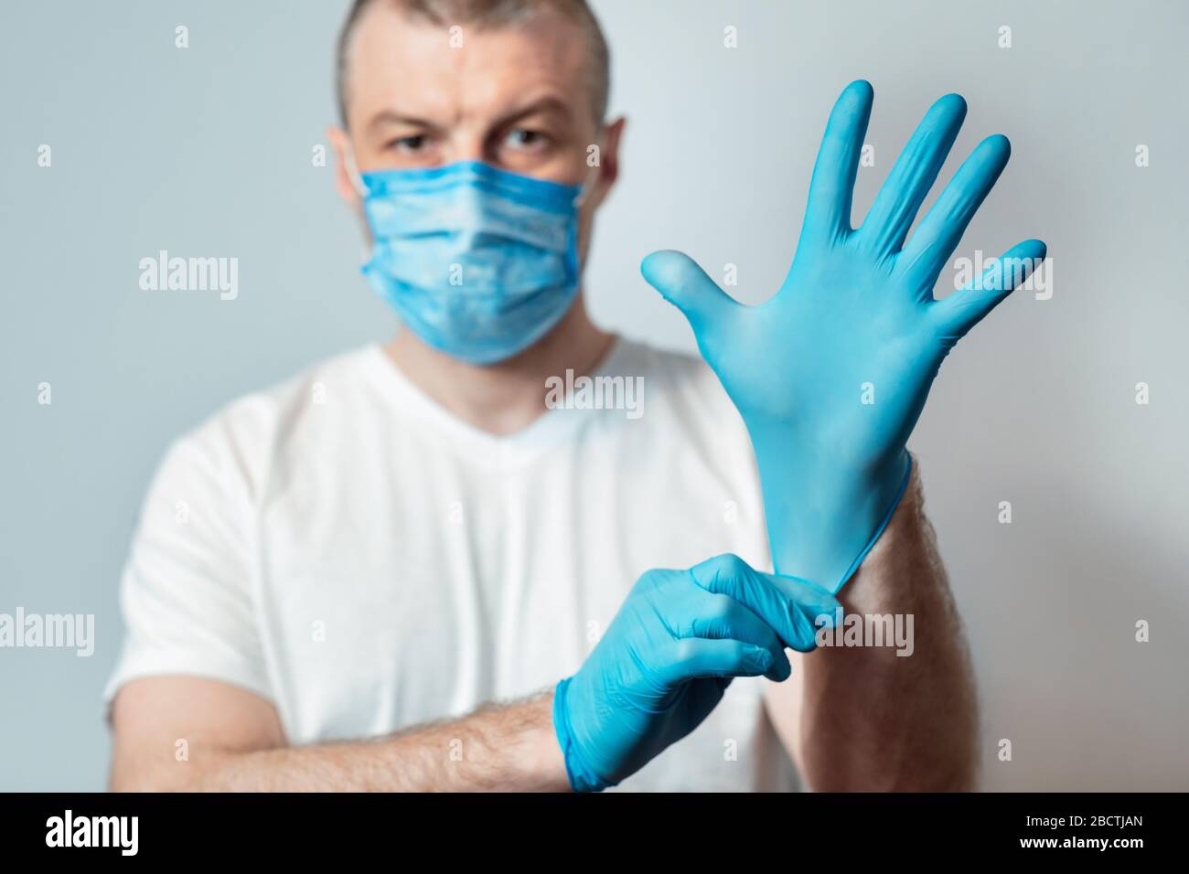 Man putting on gloves hi-res stock photography and images - Alamy