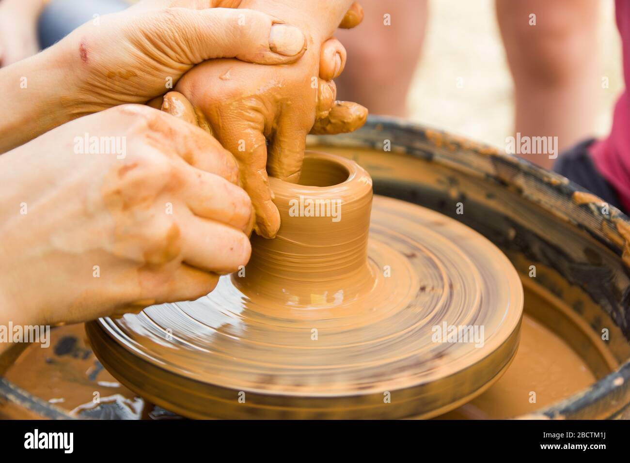 A close up view on ceramic production process on potter's wheel with ...